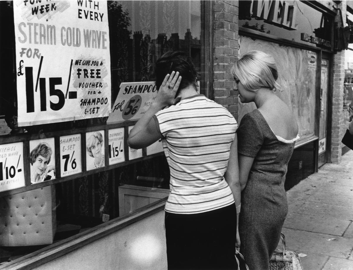 Two women outside a hairdressers in Whitechapel | London Museum