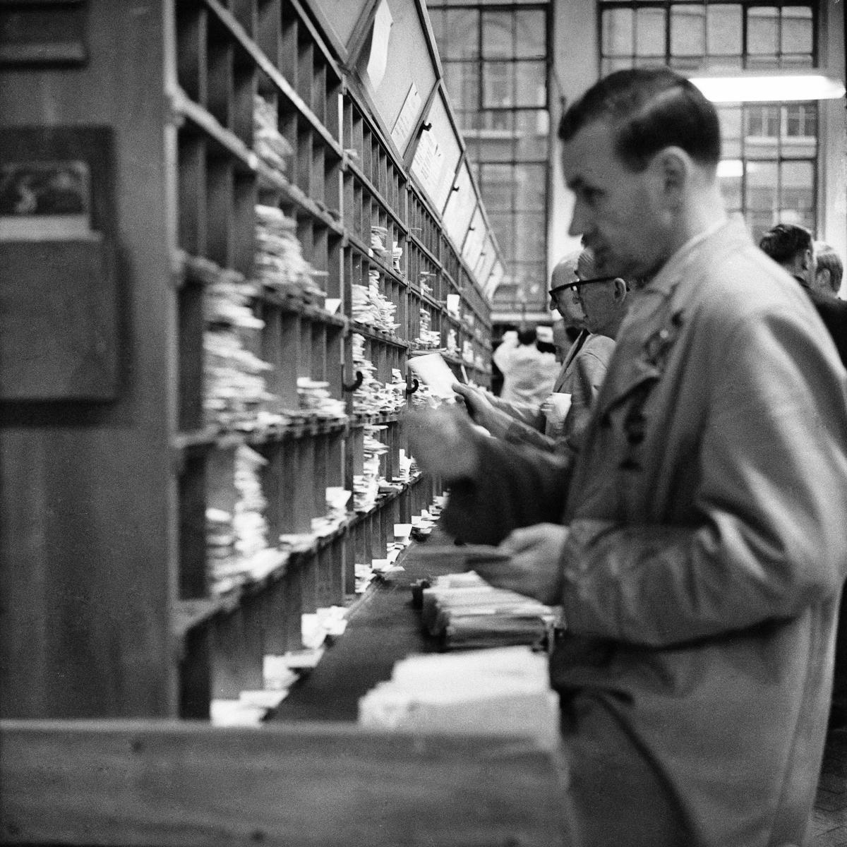 Employee at work sorting letters at the Royal Mail Mount Pleasant ...