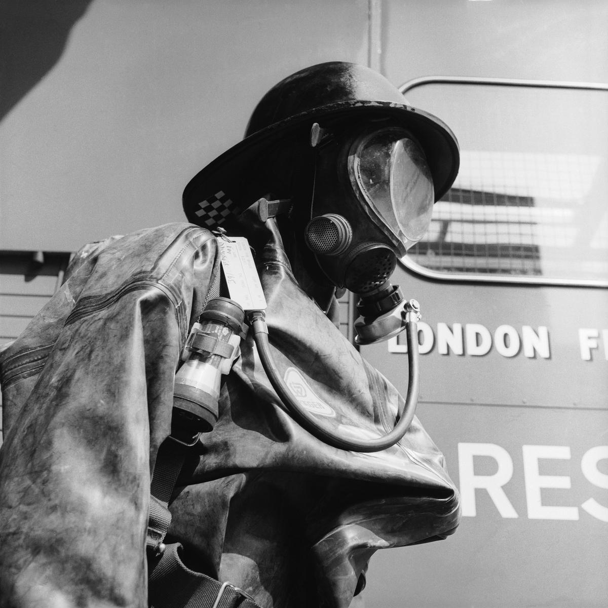 A fireman in the London Fire Brigade stands beside an engine at LFB ...