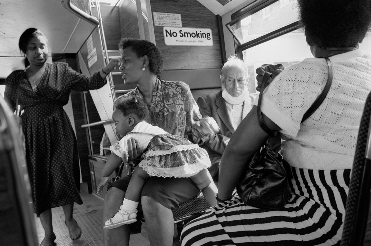 Group on the lower deck of a bus passing Rye Lane, Peckham | London Museum