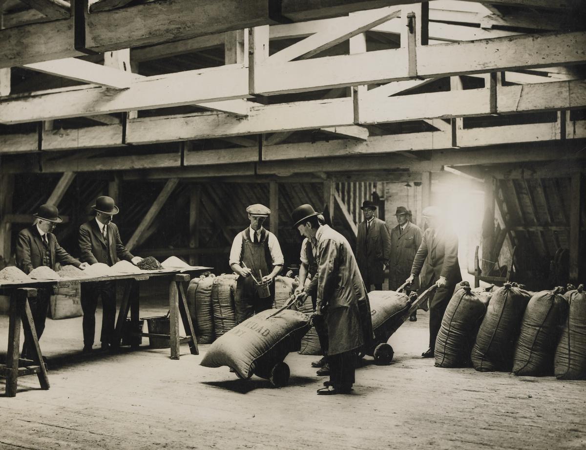 Sampling sacks of raw sugar | London Museum