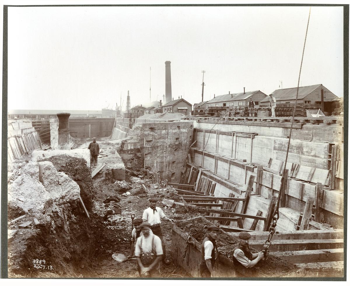 Workers extending the dry dock head of the Royal Albert dock | London ...