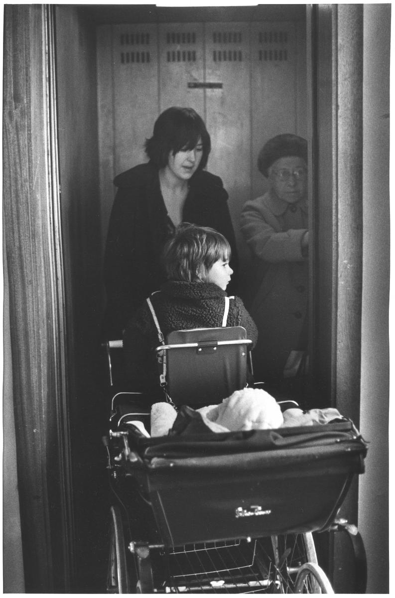 Women and young children exit a lift on Cathall Road Estate ...