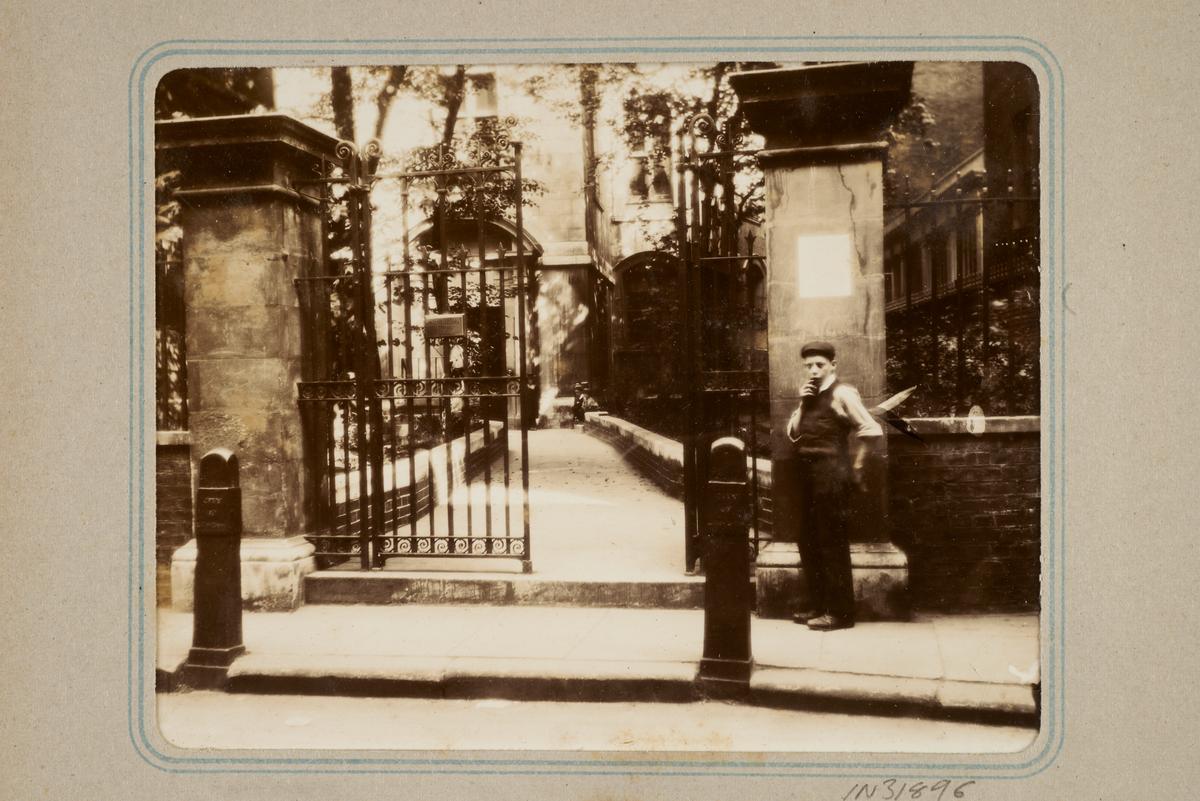 A boy outside the gates of a churchyard in Ironmonger Lane | London Museum